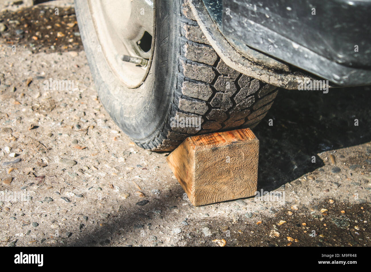 Wooden fence under the wheel for the machine. Wheel stop Stock Photo ...