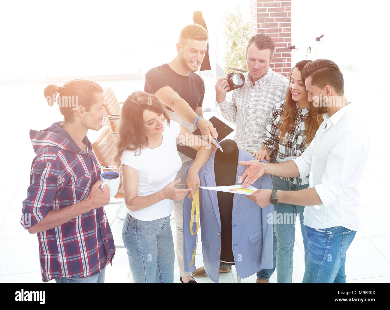 group of designers working with new models of men's clothing. photo ...