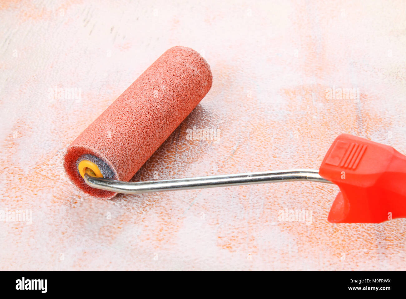 paint roll brush in white paint on plywood surface Stock Photo - Alamy