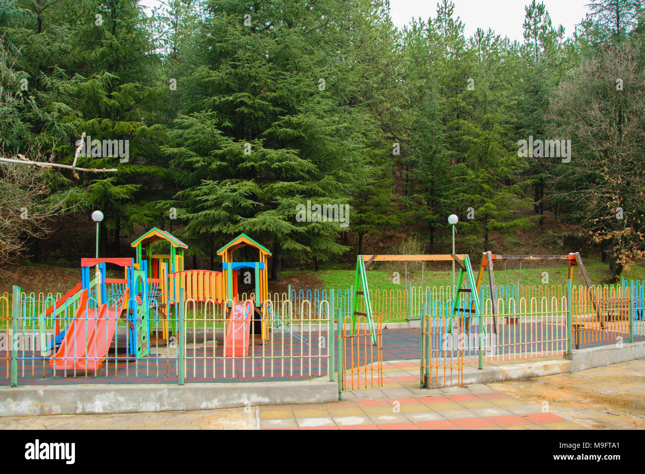 Colorful children playground in the green area Stock Photo - Alamy