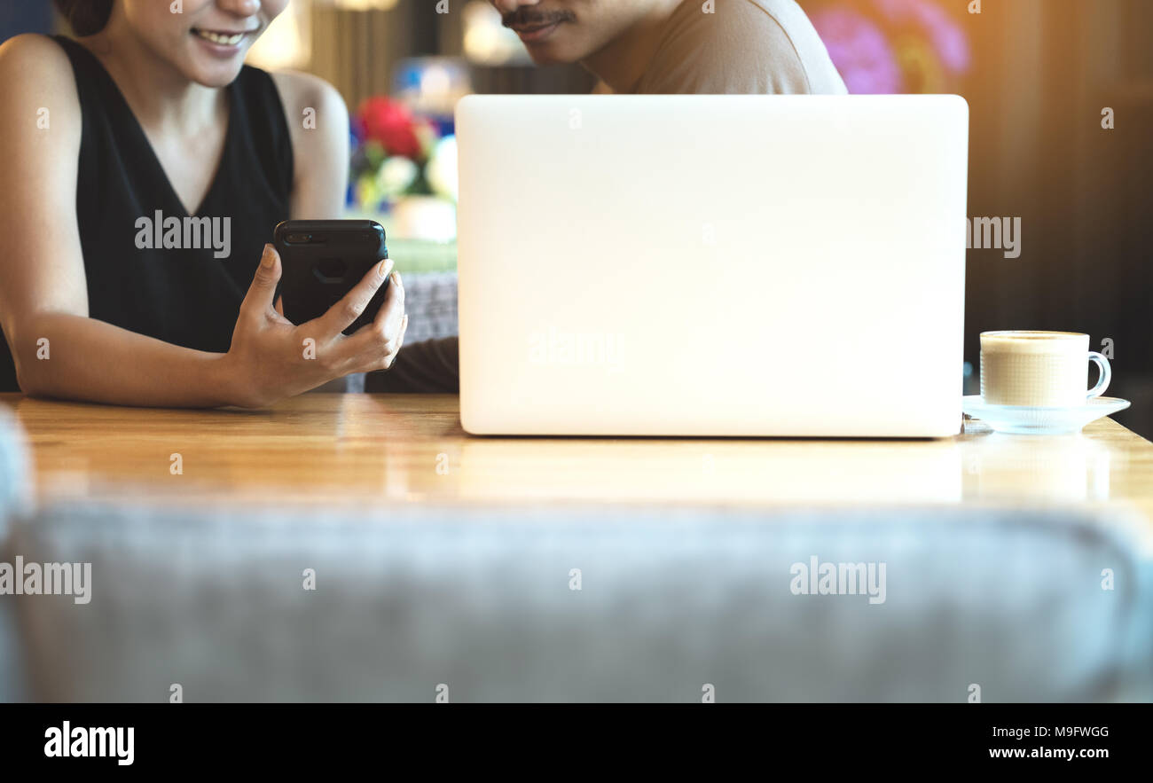 woman holding show phone screen to couple Stock Photo - Alamy