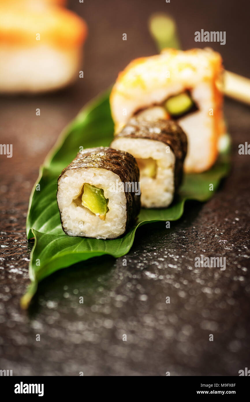 Traditional japanese sushi rolls hosomaki,uramaki on stone desk Stock ...