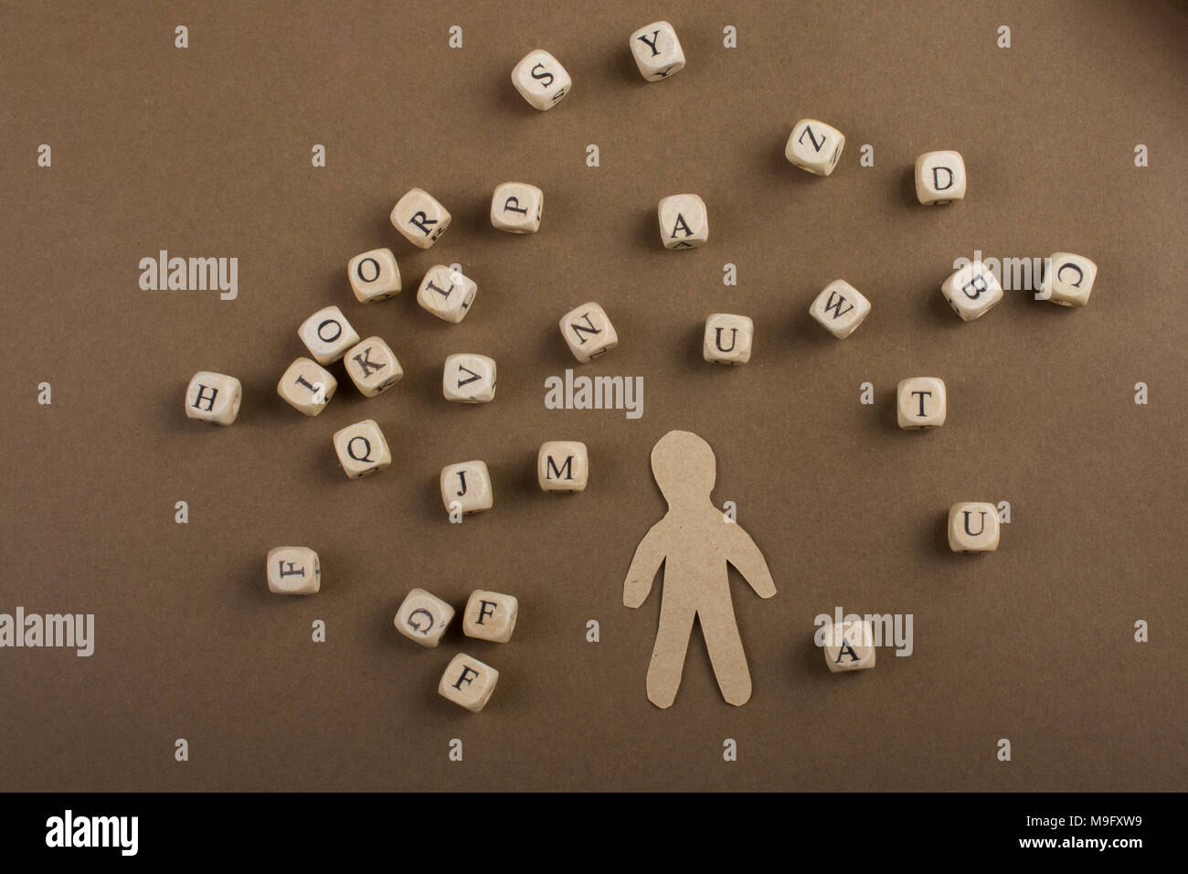 Letter cubes of made of wood and man figurine Stock Photo - Alamy