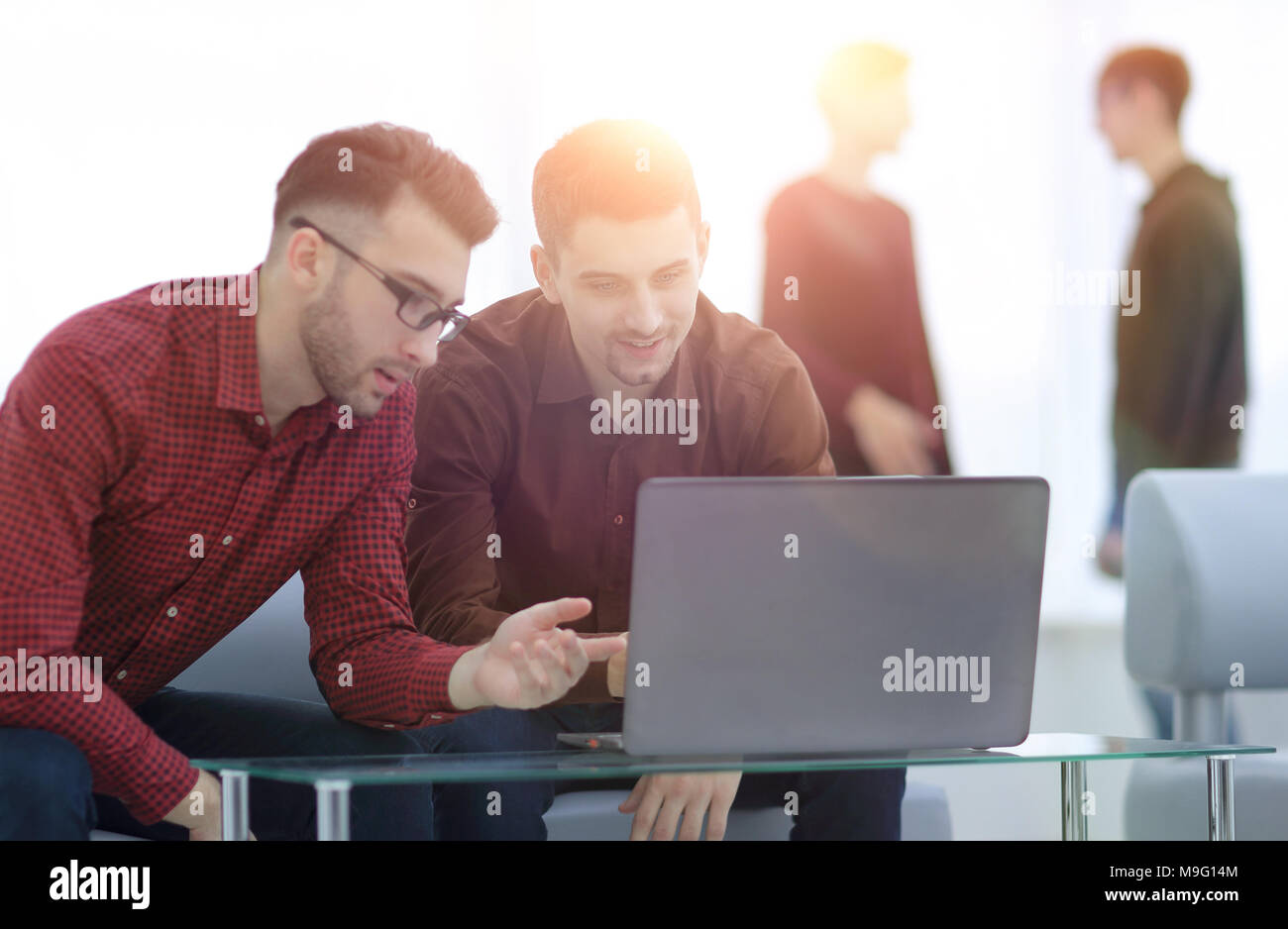 two web designers discussing a project Stock Photo - Alamy