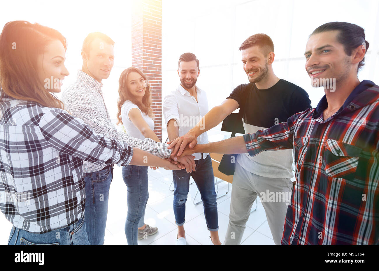 business team with hands clasped together Stock Photo - Alamy