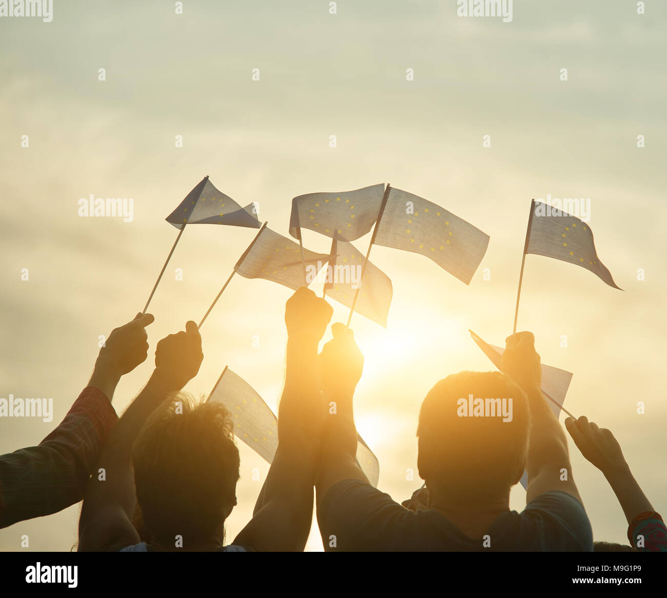 Small european union flags. Evening sunny sky background Stock Photo ...