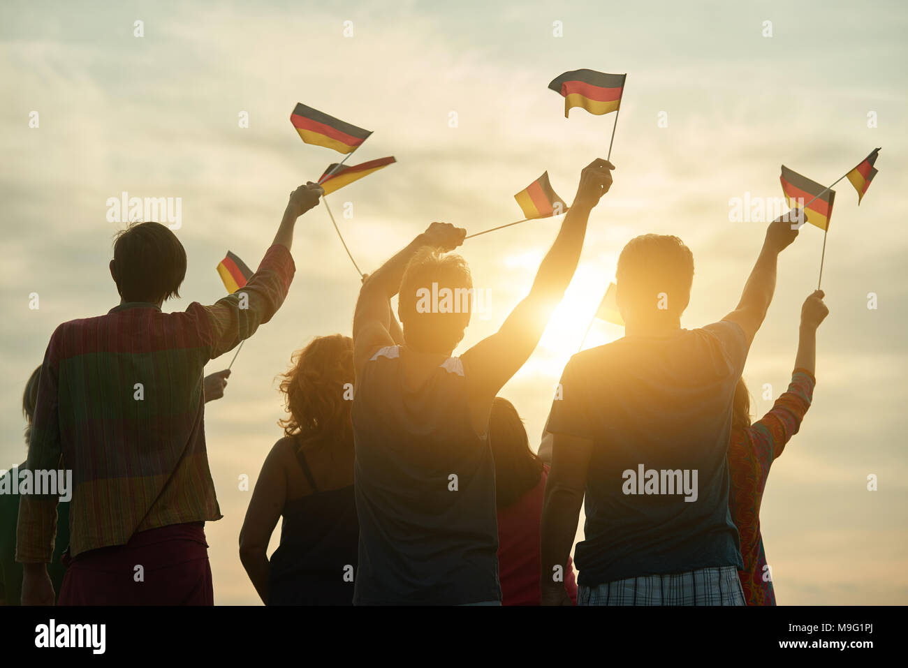 Crowd of people holding deutsch flag, back view. Silhouette of ...