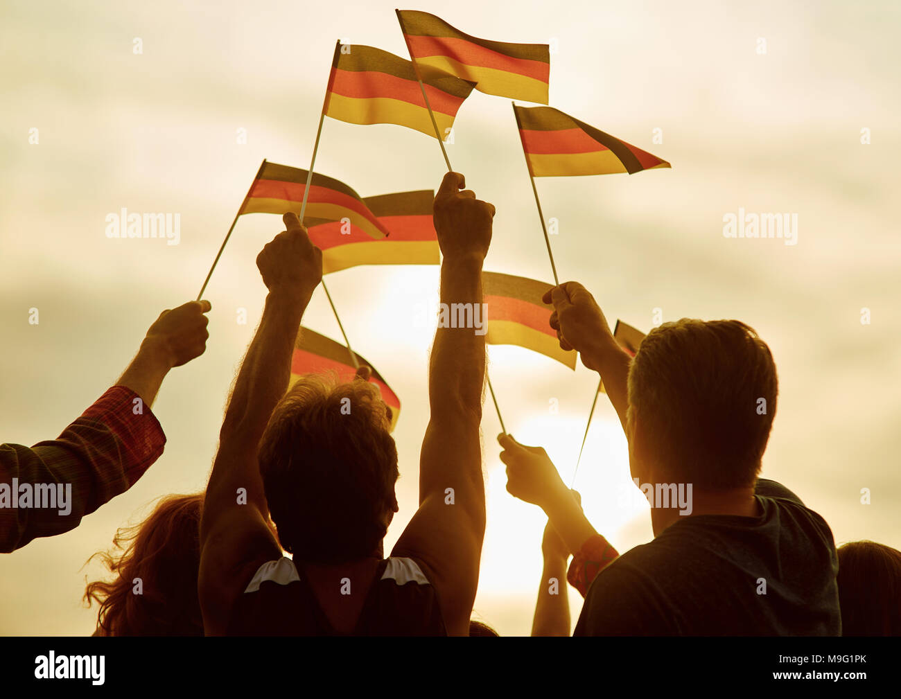 People hold german flags. Silhouette of patriotic deutsch crowd, rear ...