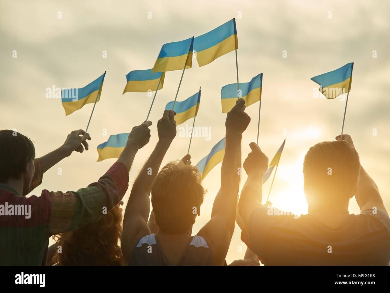 Crowd with ukrainian flags in the evening. Ukrainian revolution ...