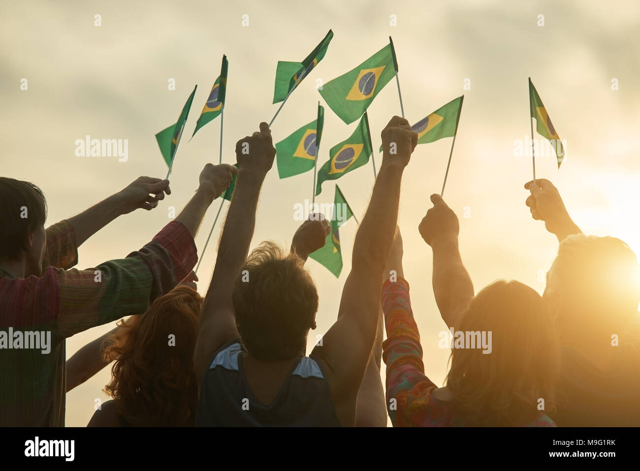 Rising up brazil flags. Crowd of people holding brazilian flags, back ...