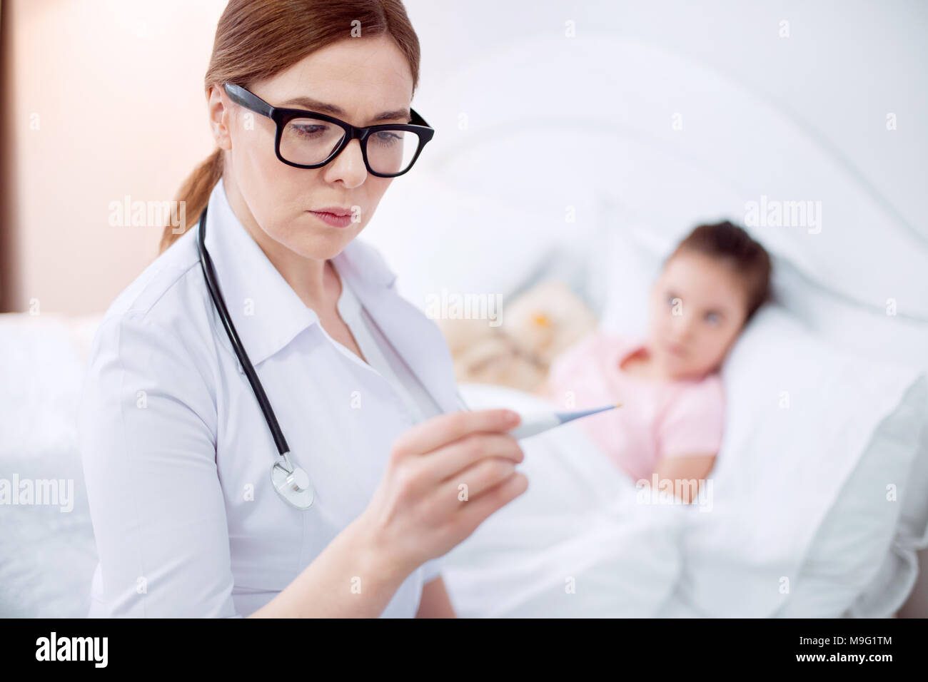 Doctor checking temperature hi-res stock photography and images - Alamy