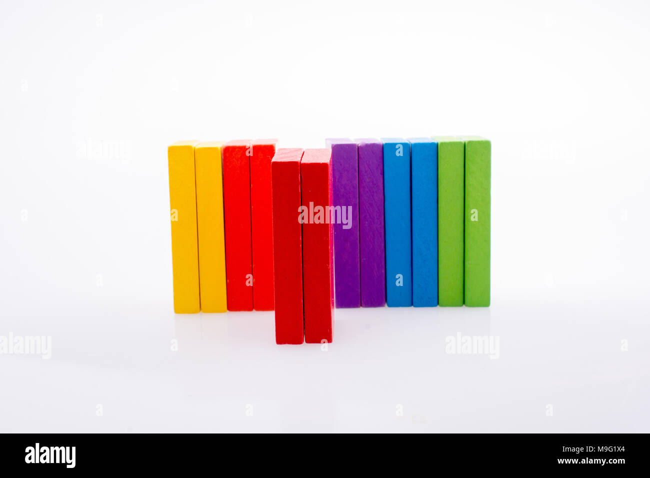 Colorful Domino Blocks in a line on a white background Stock Photo - Alamy