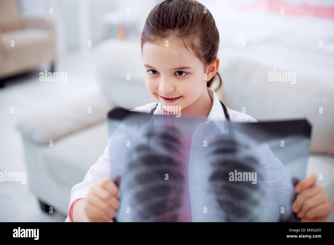 Smart beautiful girl checking radiography Stock Photo - Alamy