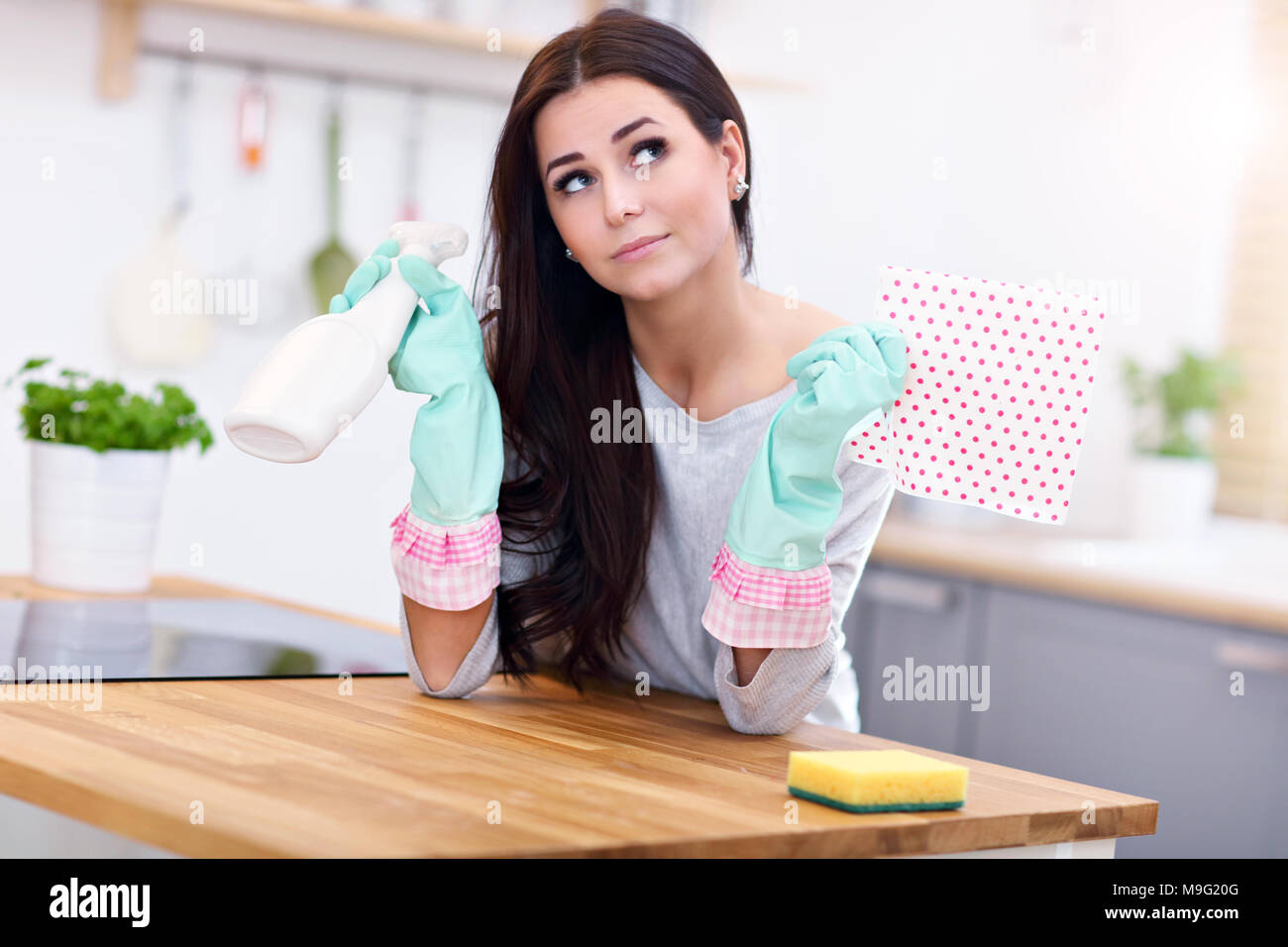 Picture of beautiful young woman cleaning the kitchen Stock Photo - Alamy