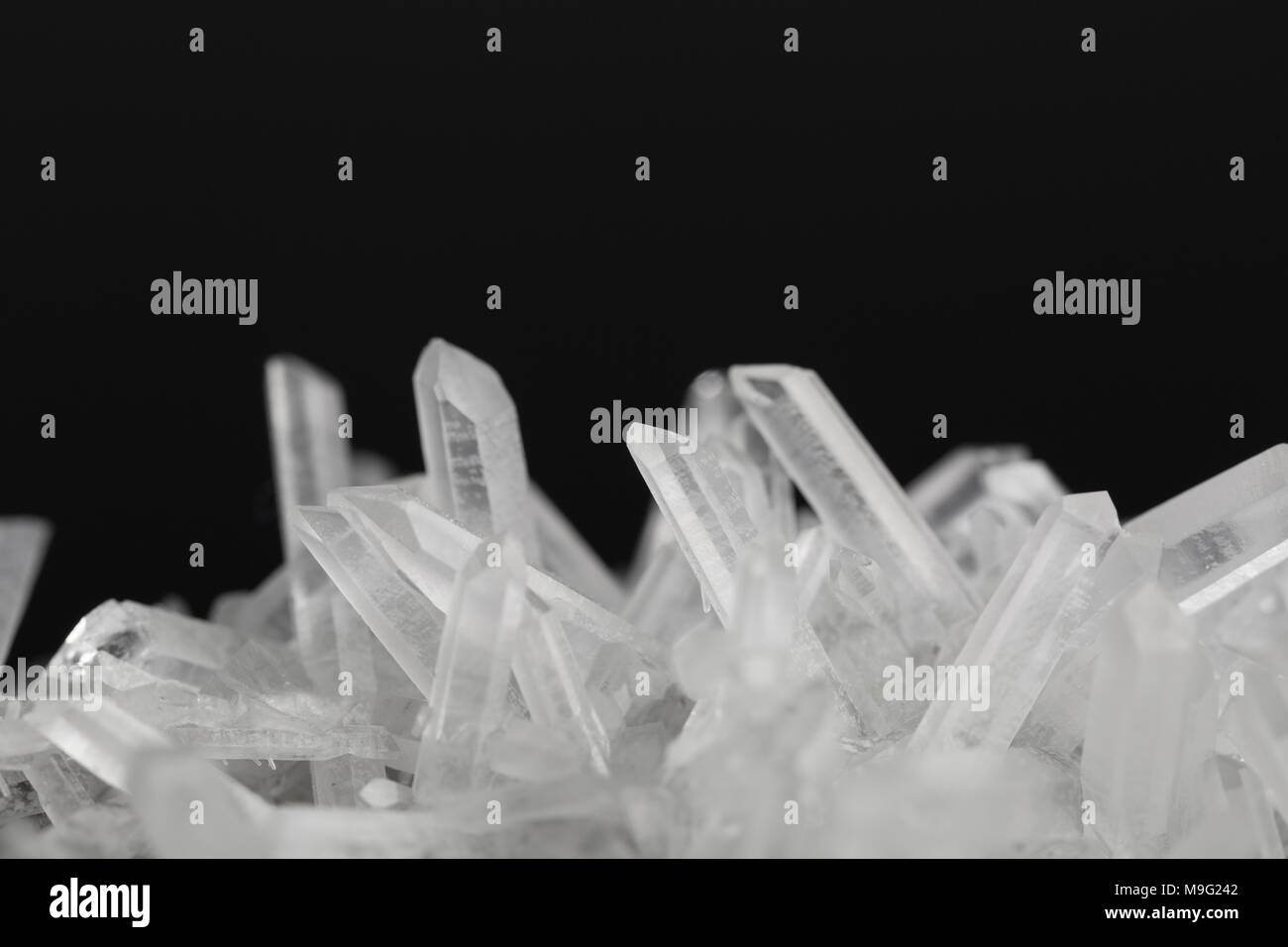 Pure Quartz Crystal cluster on black background Stock Photo - Alamy