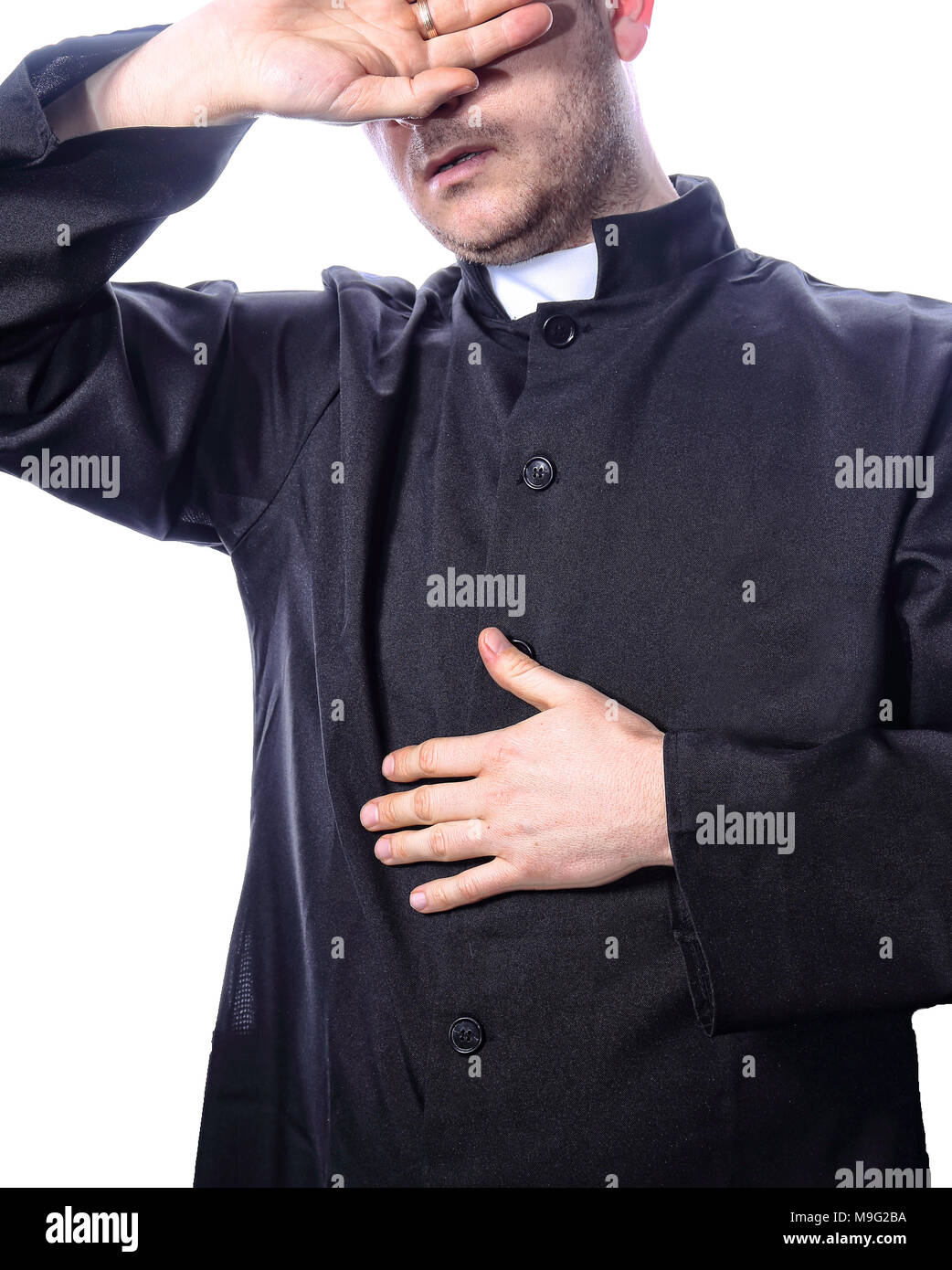 priest is covering his face with his hand Stock Photo - Alamy