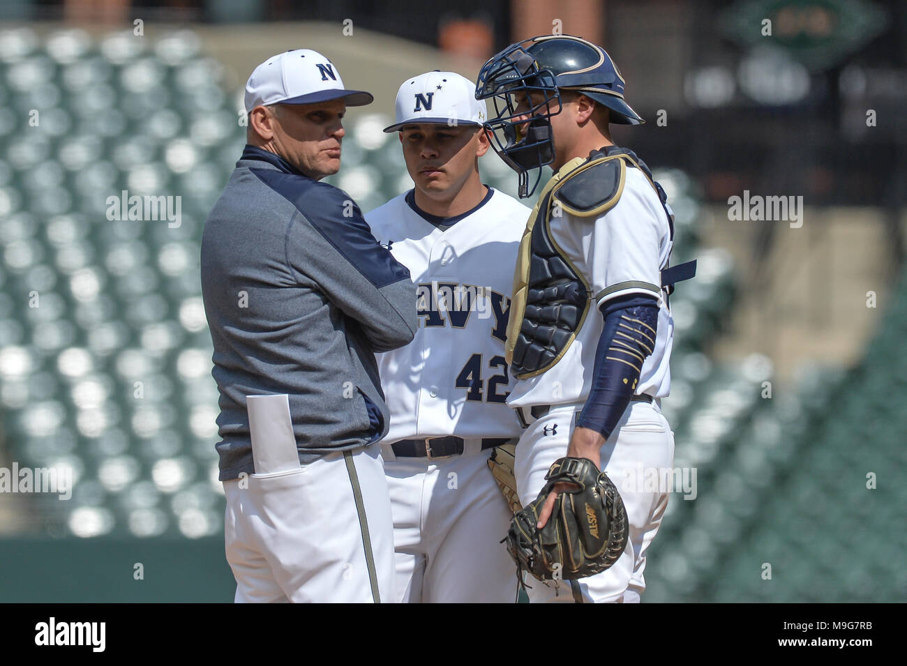 Baltimore, Maryland, USA. 25th Mar, 2018. Head Coach PAUL KOSTACOPOULOS talks with pitcher SANTE ...