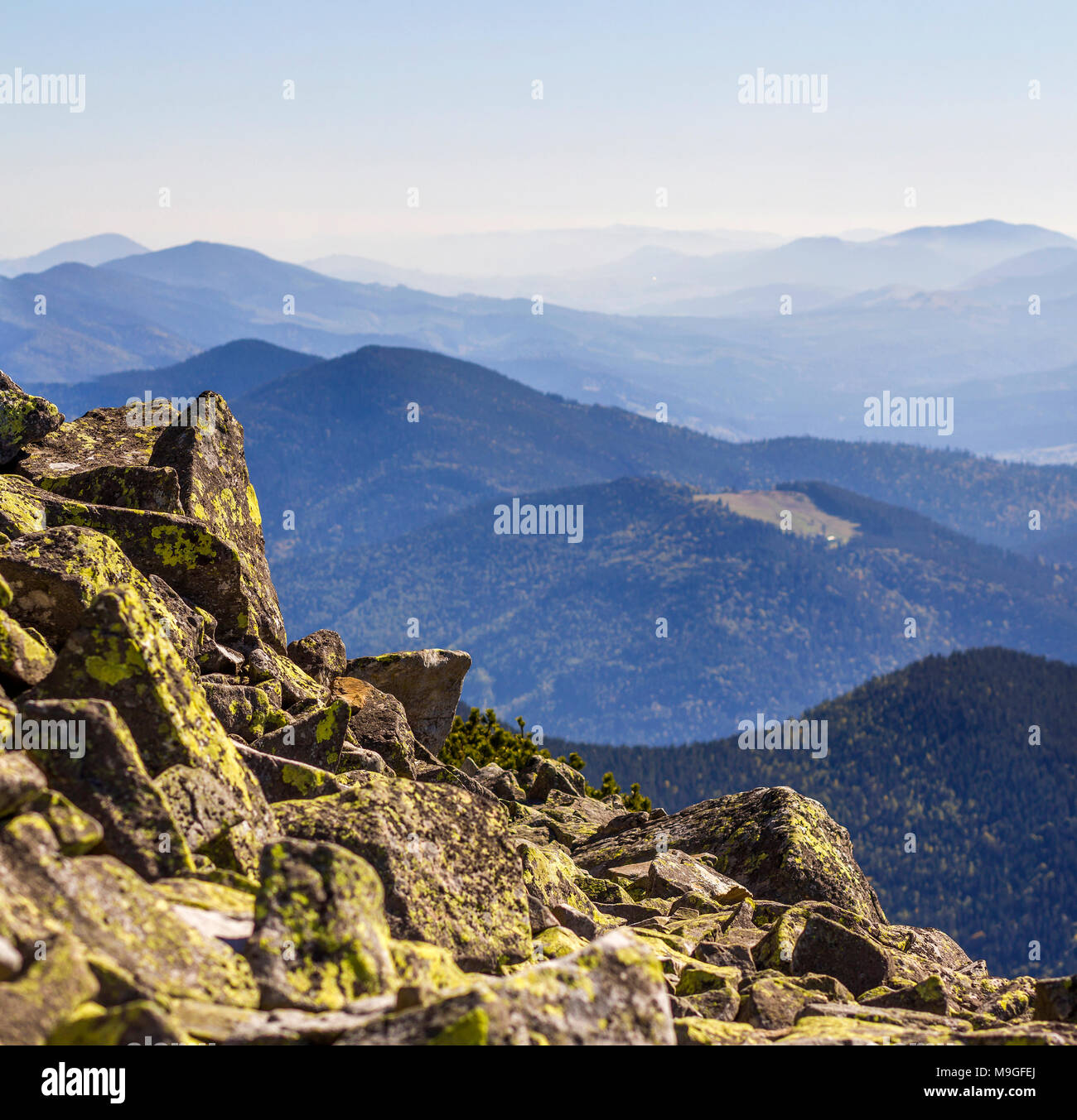 Stack of stones covered with moss on top of a mountain on mountains ...