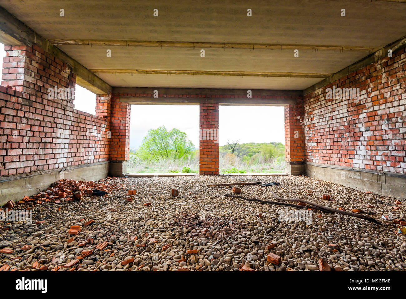 Interior of an old building under construction. Orange brick walls in a ...
