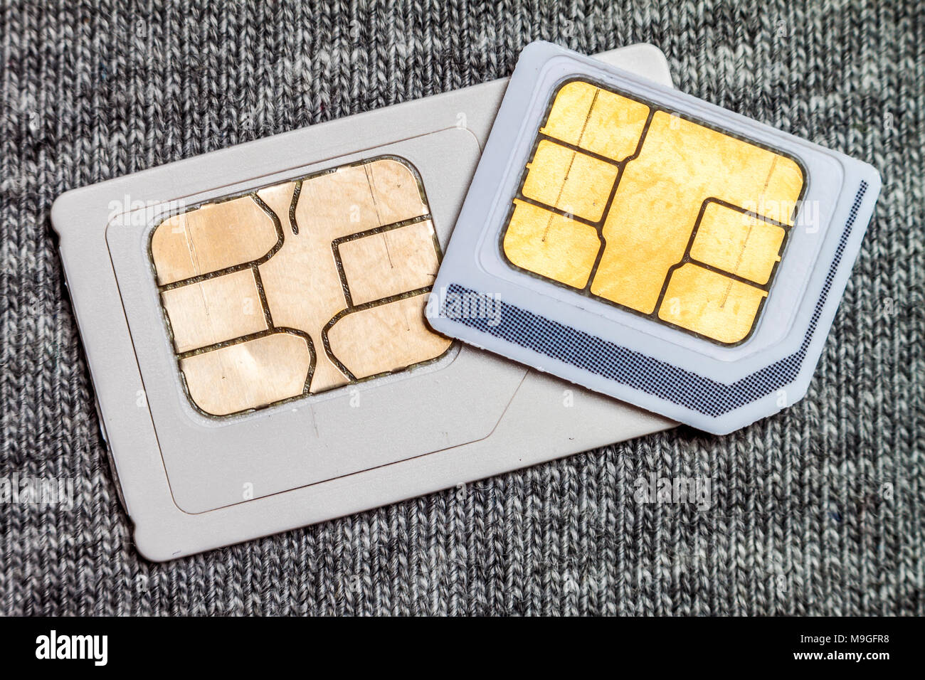 Set of mini and micro simcard. Isolated on grey cloth texture ...