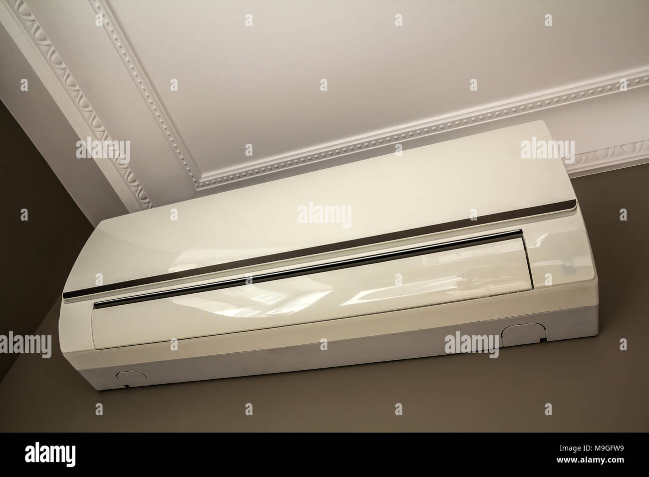 Cool air conditioner system on dark wall in room interior Stock Photo ...