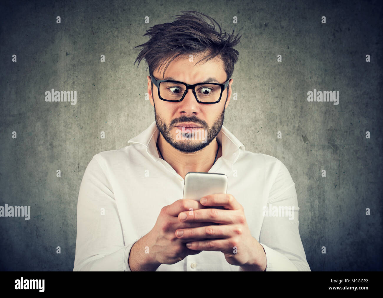 Scared looking at phone hi-res stock photography and images - Alamy