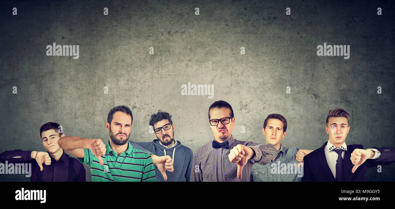 angry, unhappy, group of young men showing thumbs down gesture Stock ...