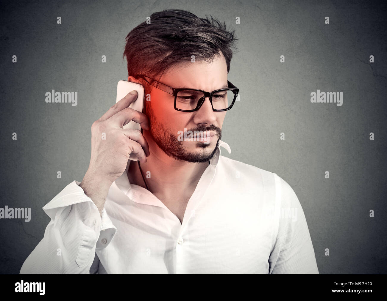 Man on the phone with headache. Upset unhappy guy talking on a ...