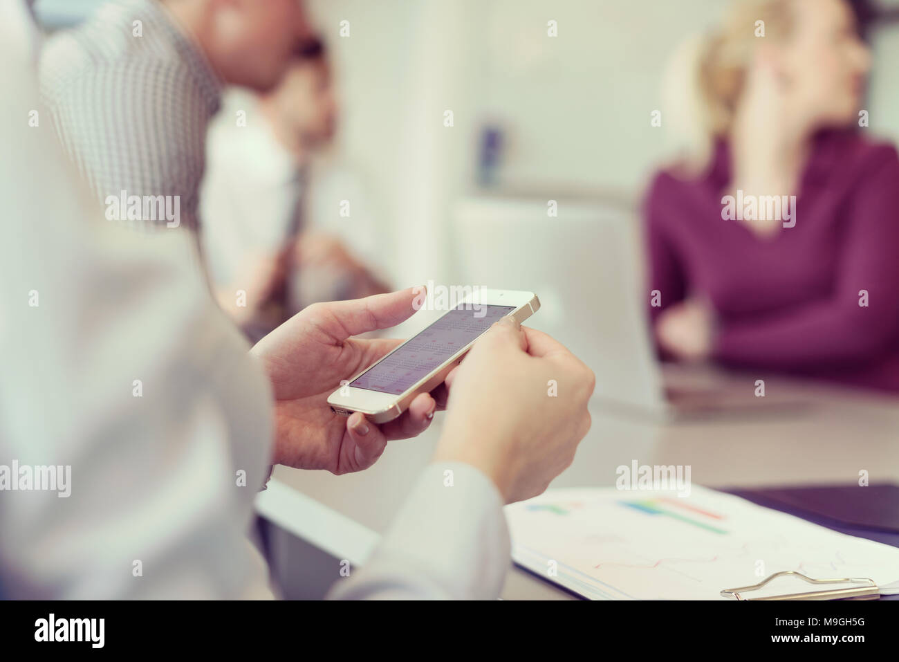 close up of businesswoman hands using smart phone, people group in ...
