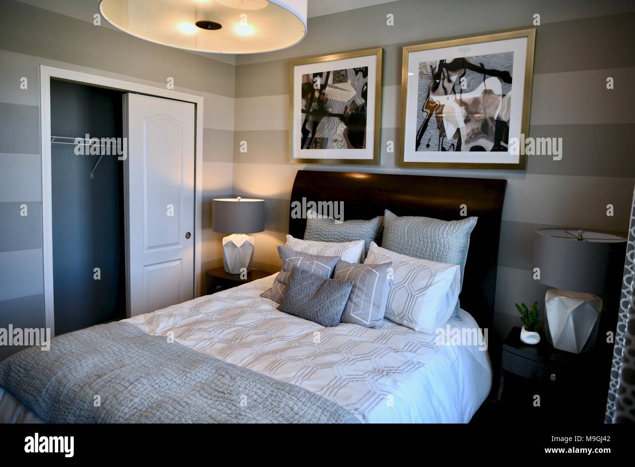 View of modern bedroom with bed inside decorated home Stock Photo - Alamy