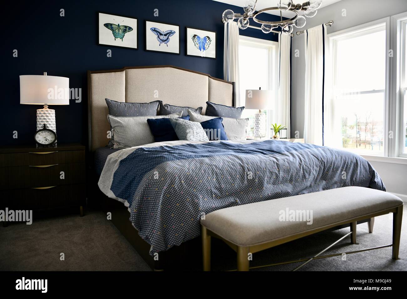 View of modern bedroom with bed inside decorated home Stock Photo - Alamy