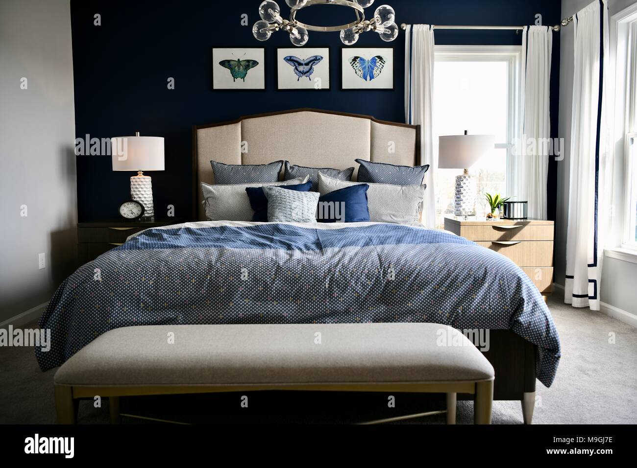 View of modern bedroom with bed inside decorated home Stock Photo - Alamy