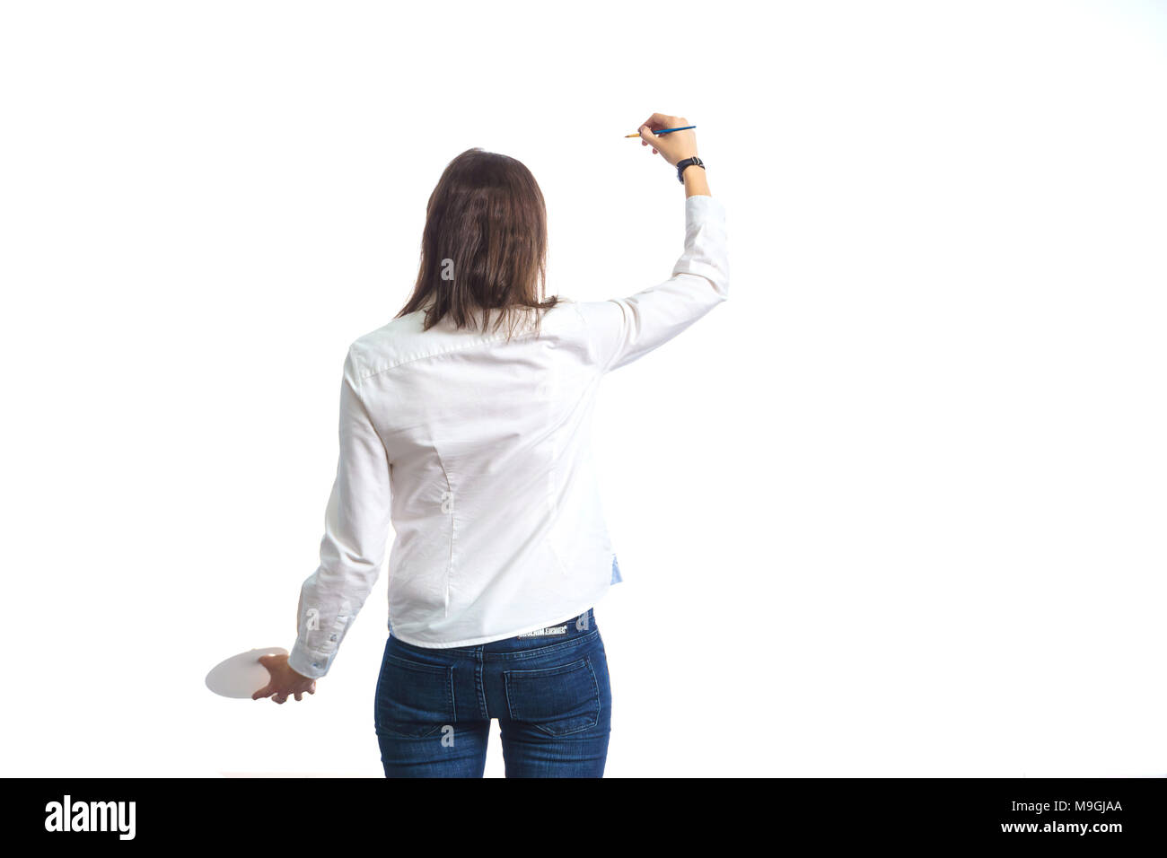 Isolated portrait of an artist standing next to an empty wall ready for ...