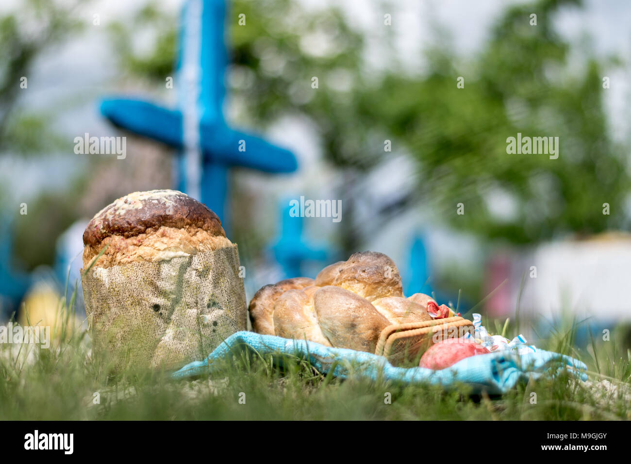 Gifts as sweet bread and sweets on a grave during Memorial Easter ...