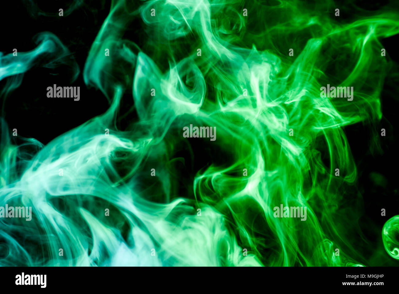Colorful green smoke on a black isolated background. Background from ...