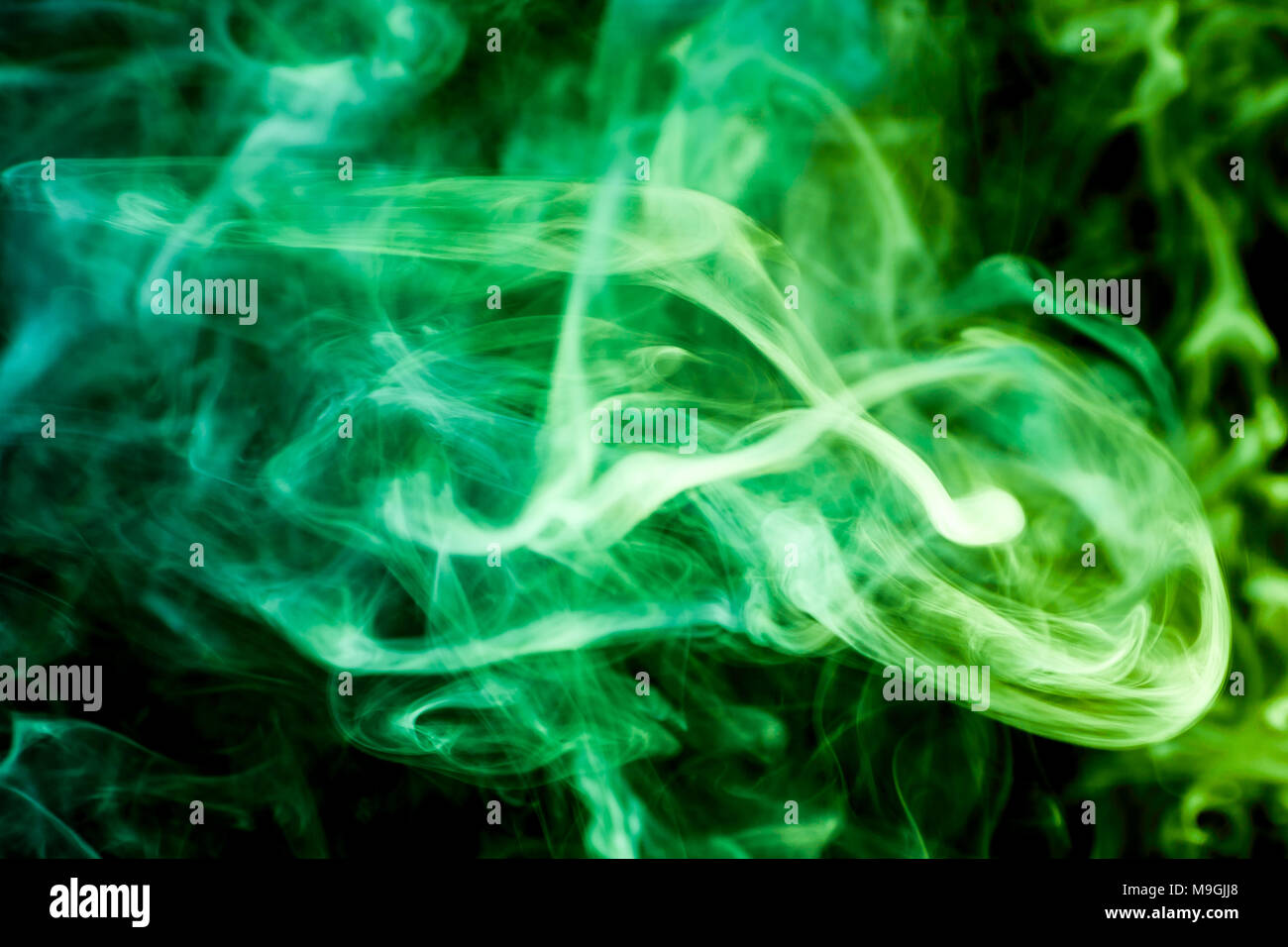Colorful green smoke on a black isolated background. Background from ...