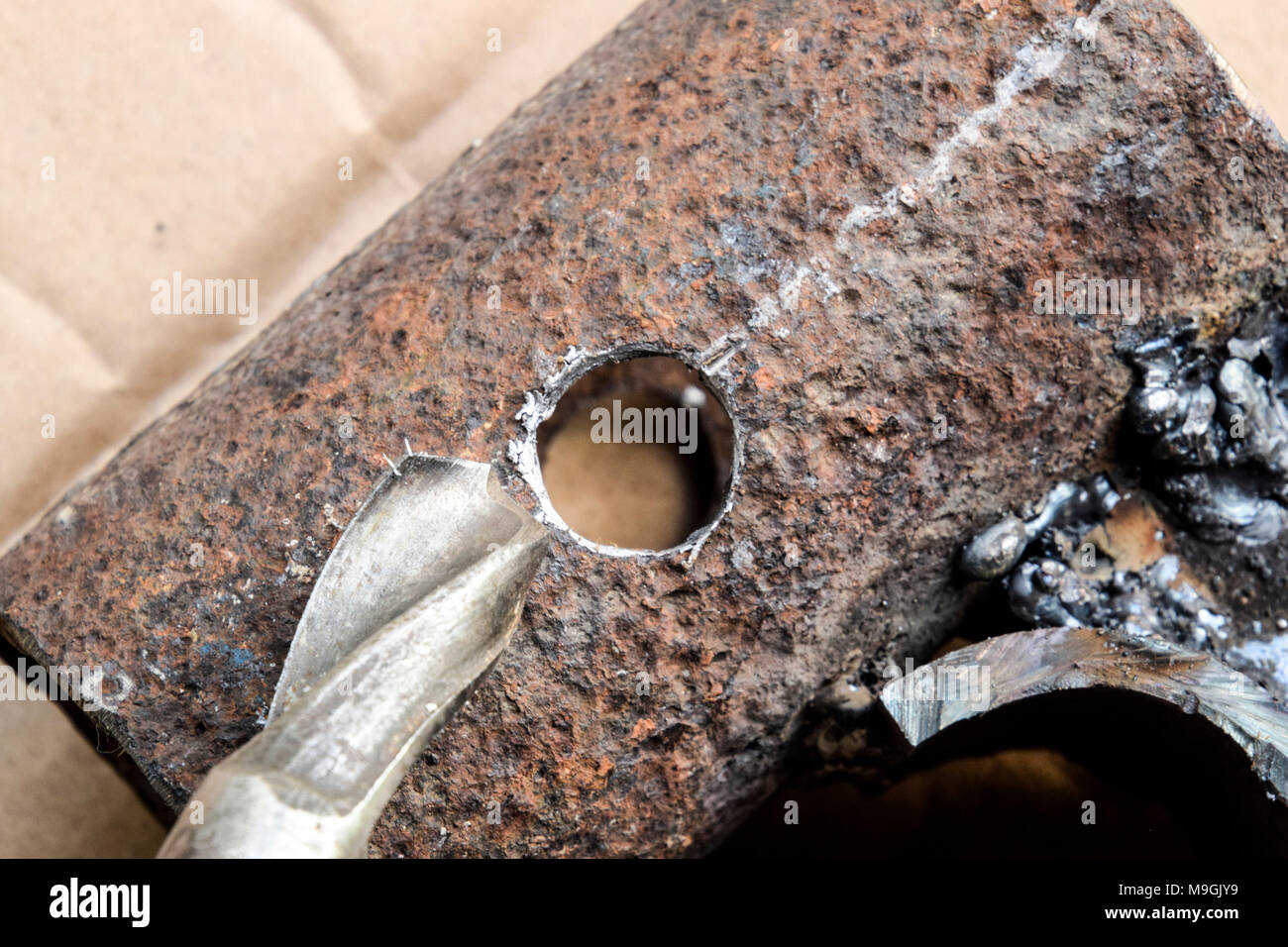 Drill for metal. A drilled hole in the steel part Stock Photo - Alamy
