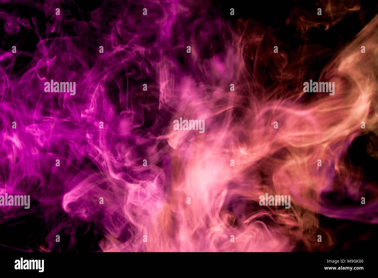Colorful pink and red smoke on a black isolated background. Background ...