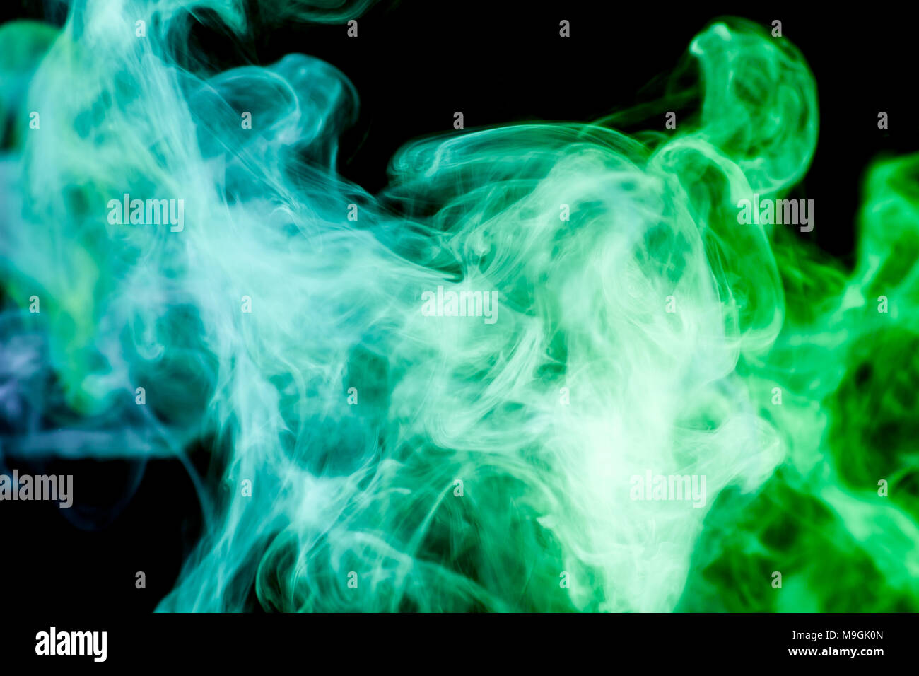 Colorful green smoke on a black isolated background. Background from ...