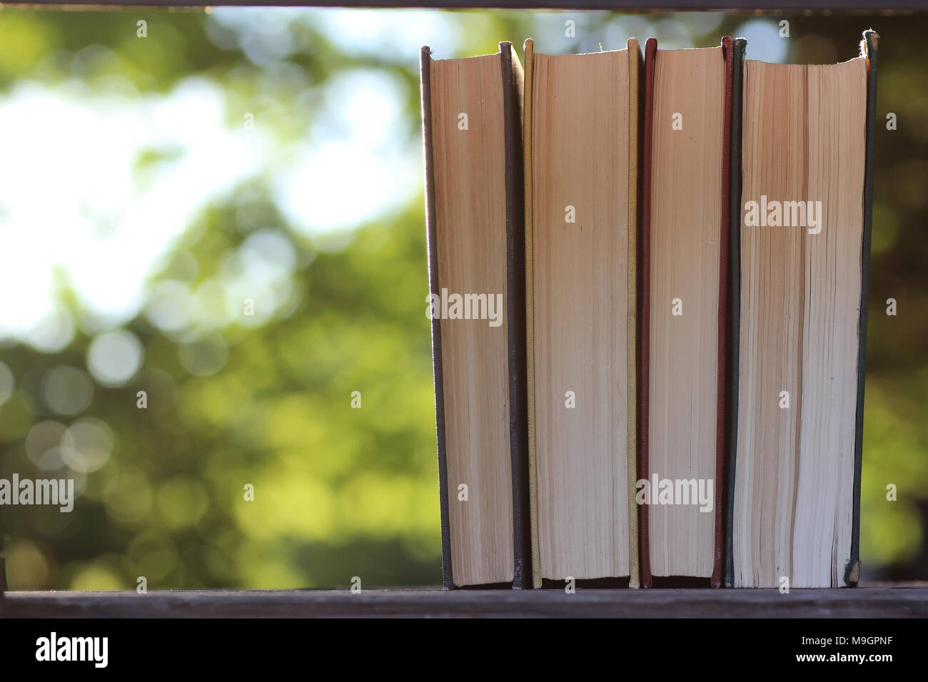 book stack background table wooden outdoor Stock Photo - Alamy