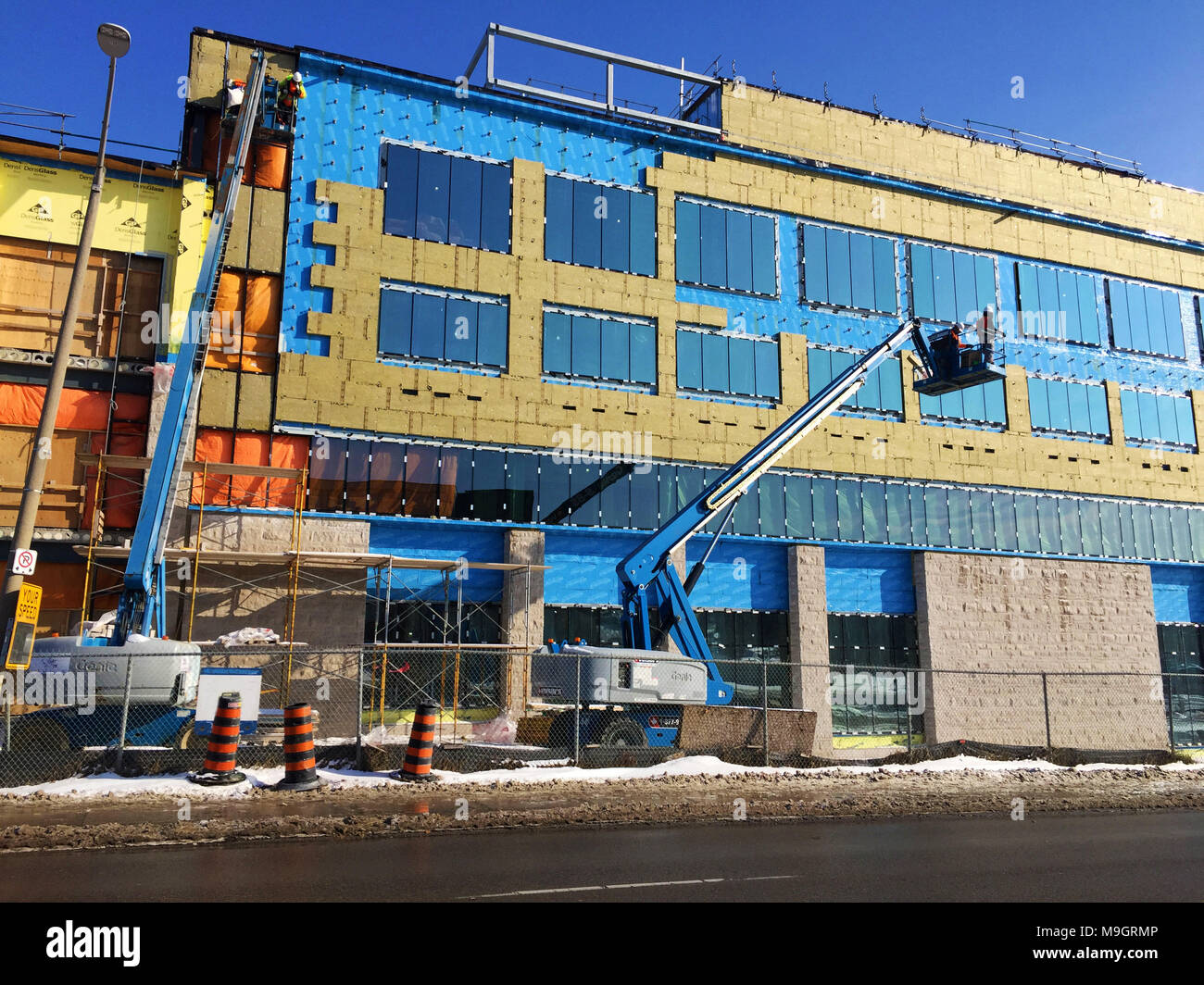 Construction workers install large glass hi-res stock photography and ...