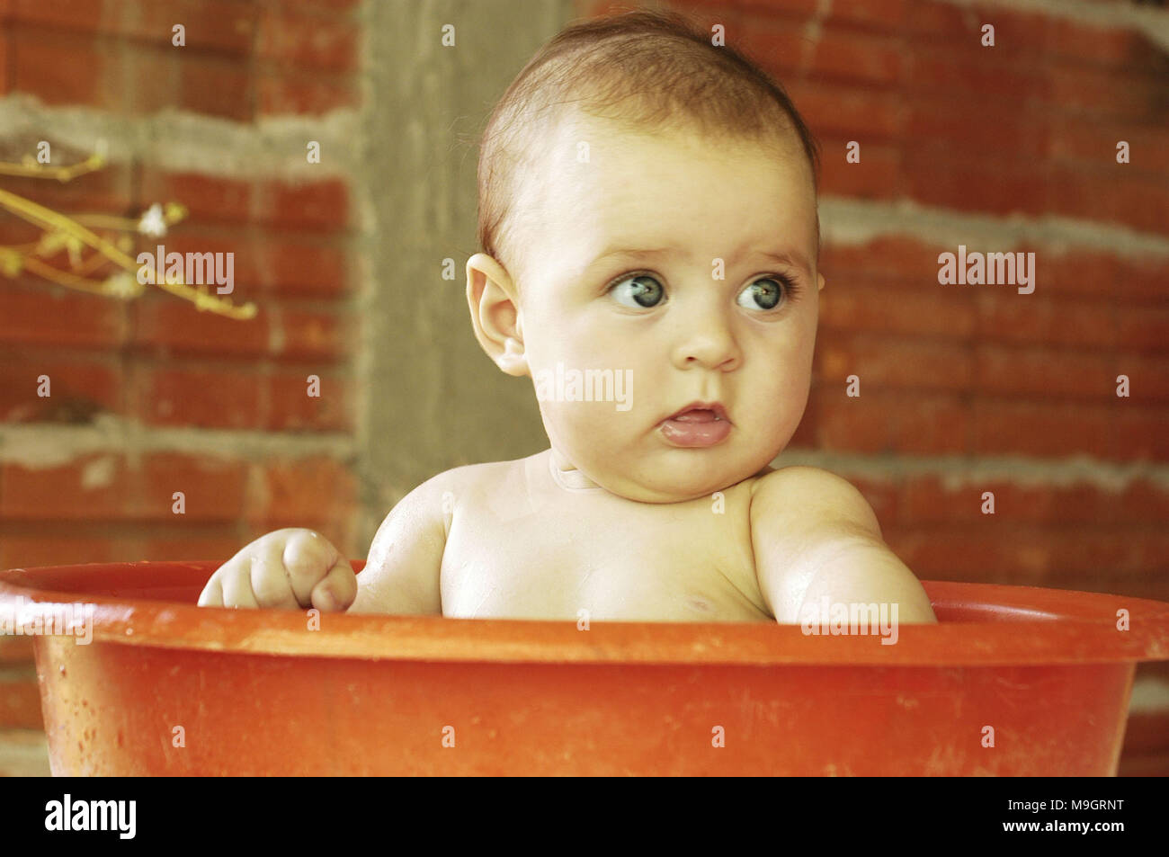 Baby, Bath in basin, isolated on white background Stock Photo - Alamy