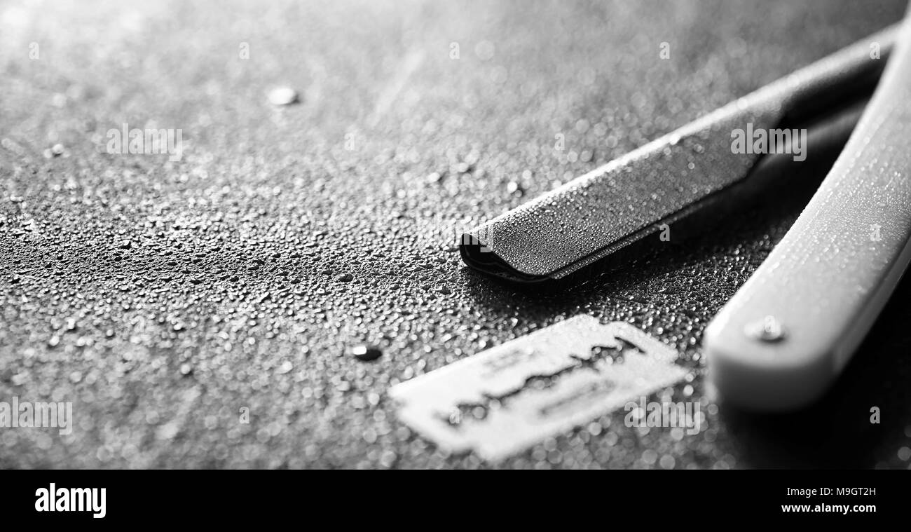 A dangerous razor and a metal blade on the table. Men's shaving Stock ...