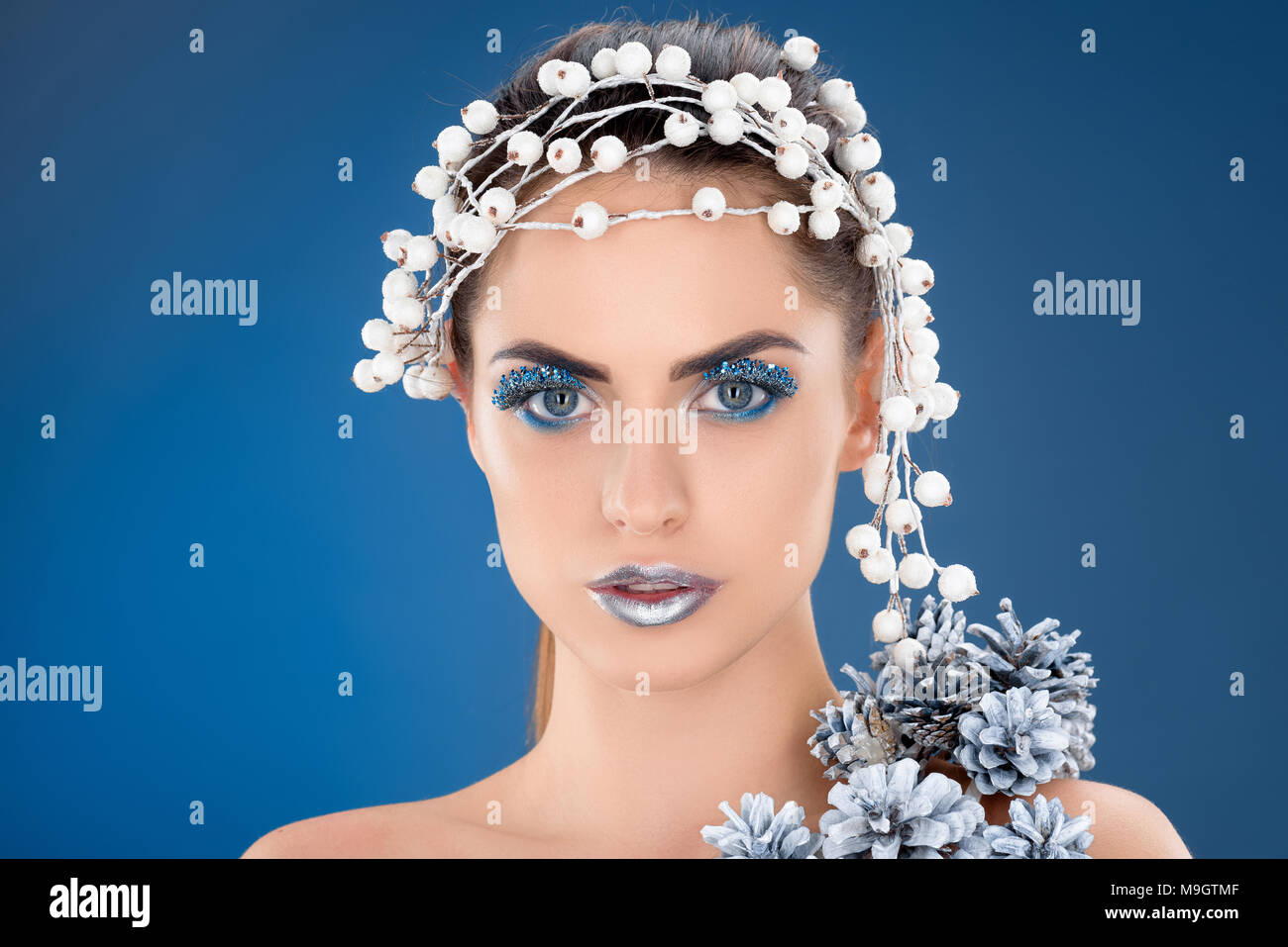 tender woman with hair accessory, christmas pine cones, winter makeup ...