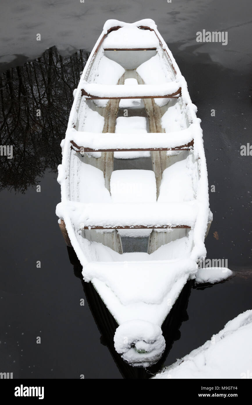 Lone moored boat covered in snow from above Stock Photo - Alamy