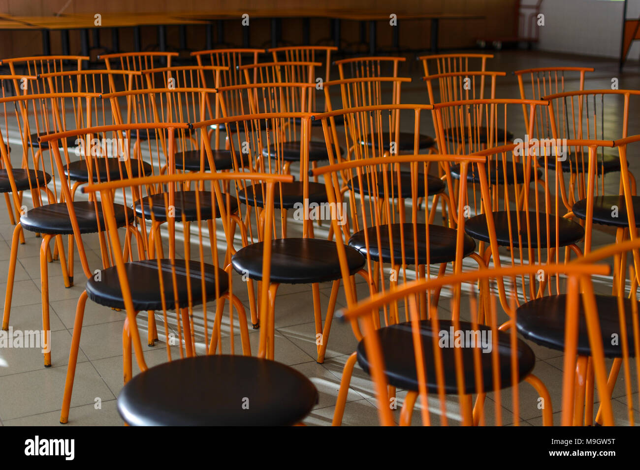 orange iron chairs, pattern of chairs, leather chair Stock Photo - Alamy