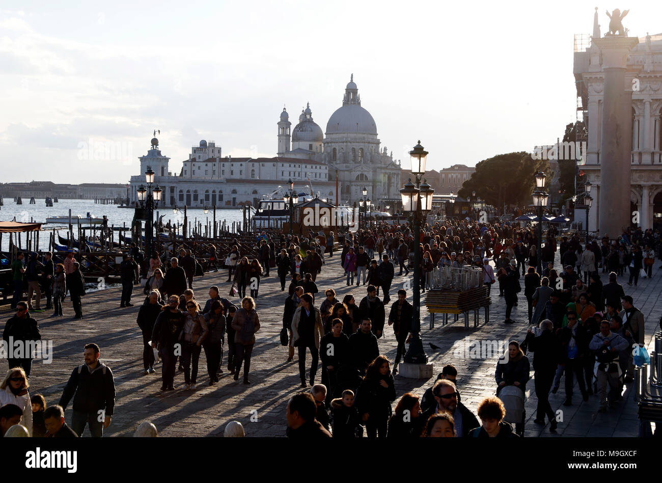 Tourists pack the waterfront of Venice, Italy near St. Marks square ...