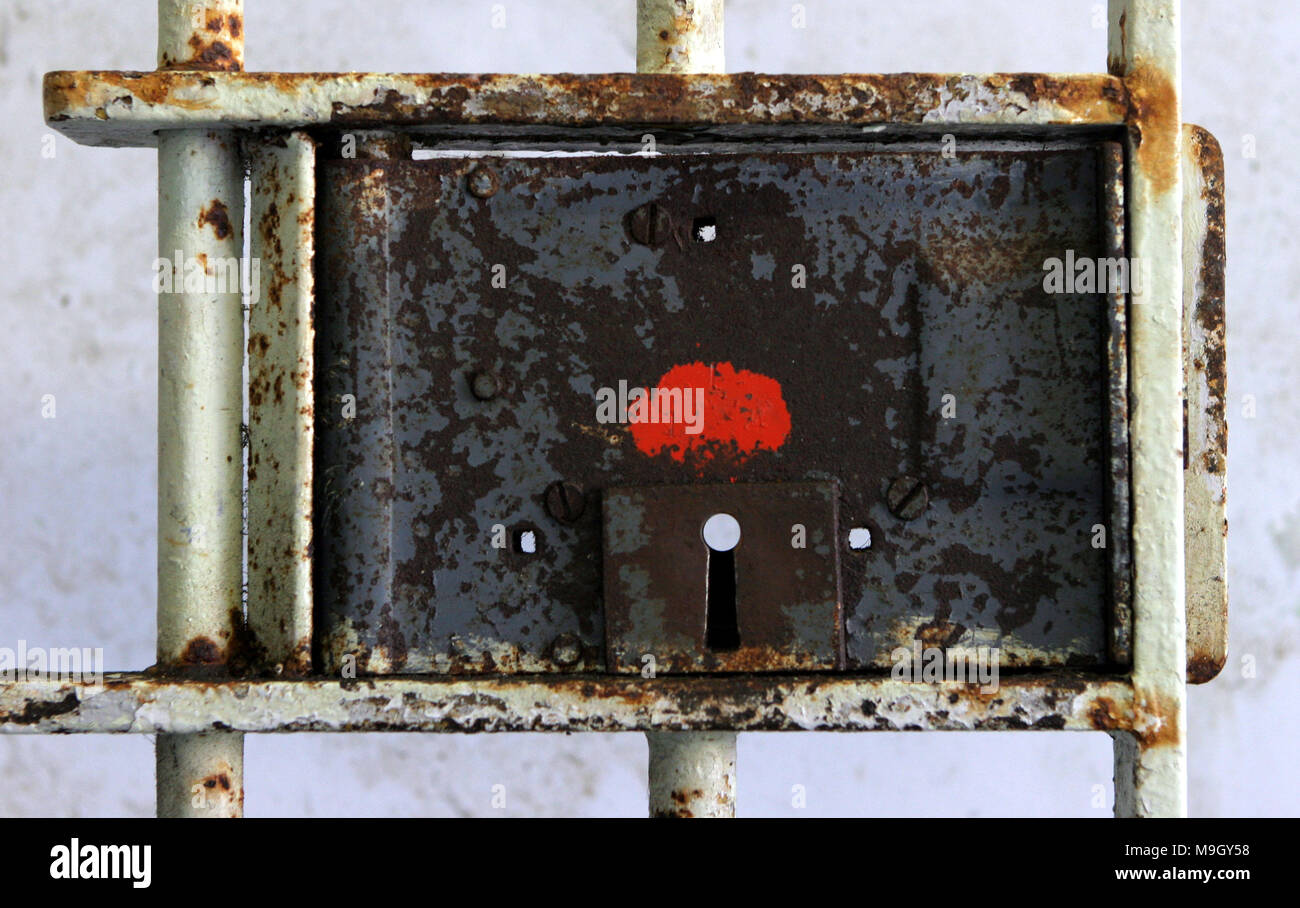 An aged lock guards an empty prison cell on Robben Island off Cape Town ...