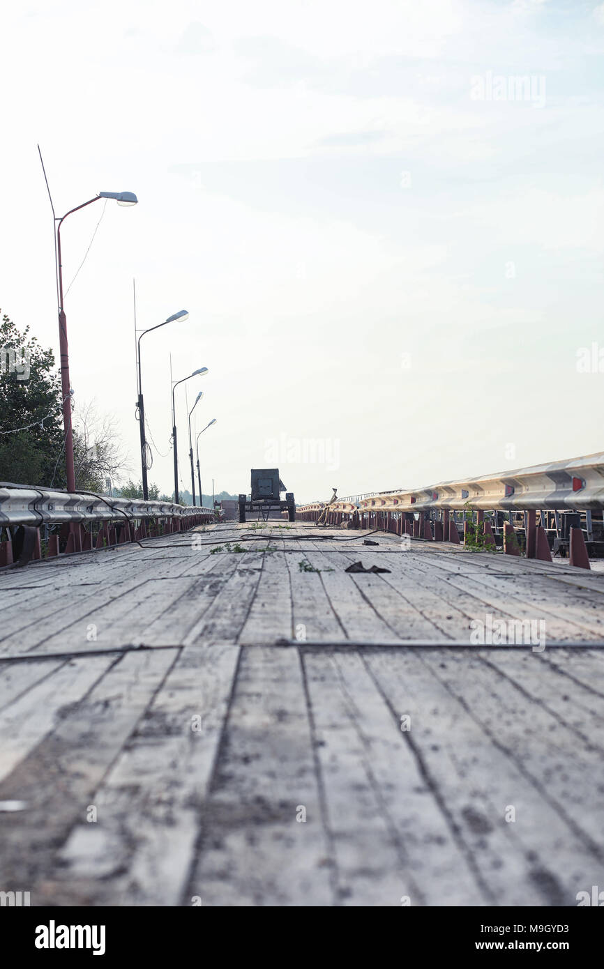 Wooden bridge on the river bank. A wooden road with pillars. Pan Stock ...
