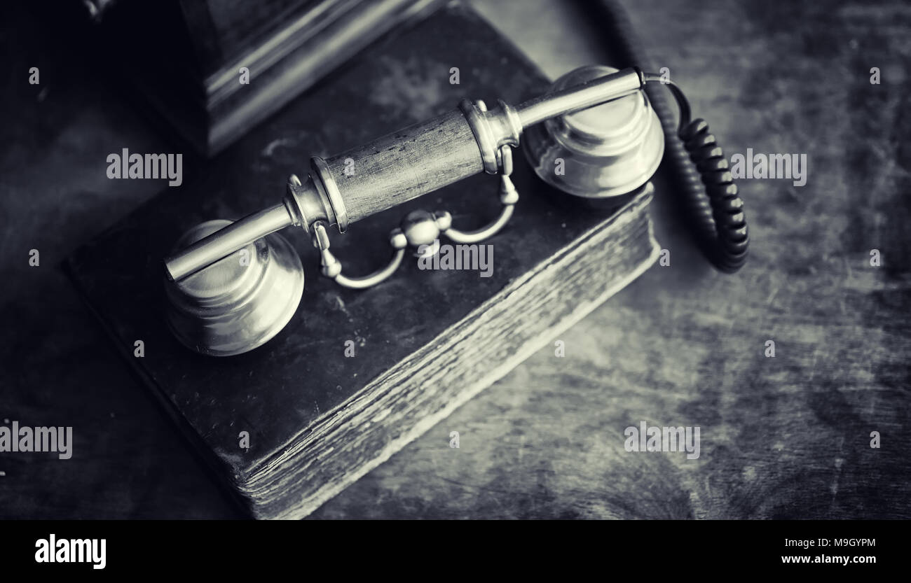 Old telephone and retro book on the desk. The phone of the past Stock ...